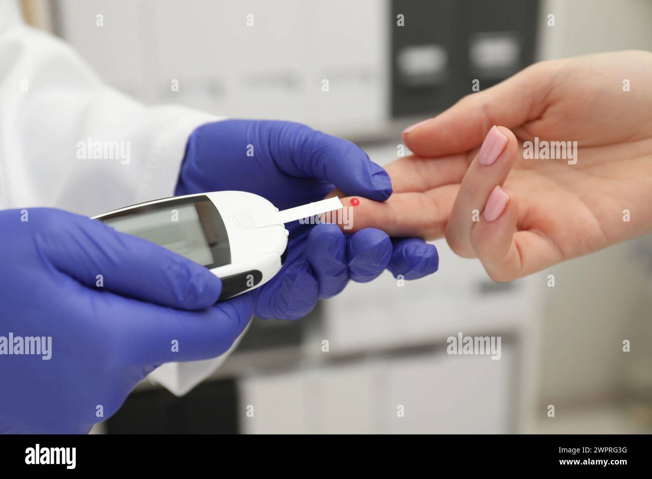 Diabetes. Doctor checking patient's blood sugar level with glucometer ...