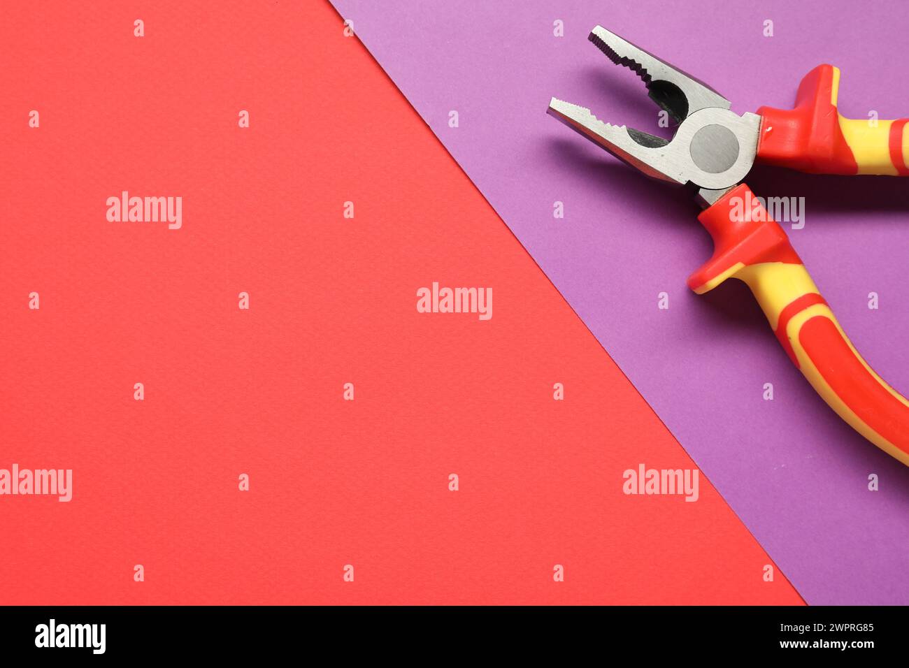 Combination pliers on color background, top view. Space for text Stock ...