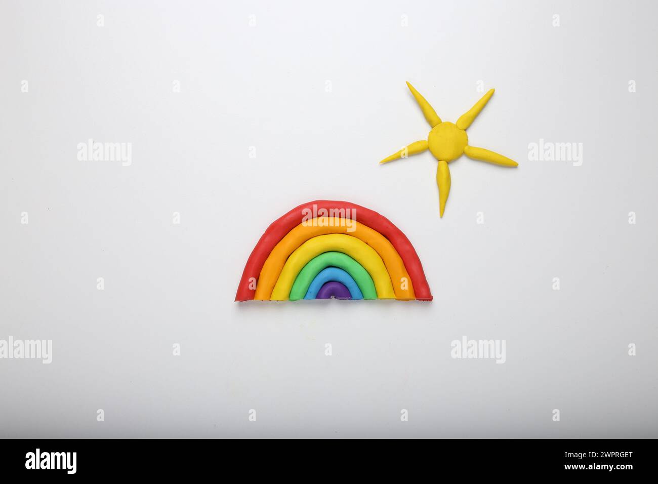 Rainbow and sun made of plasticine on white background, top view Stock ...
