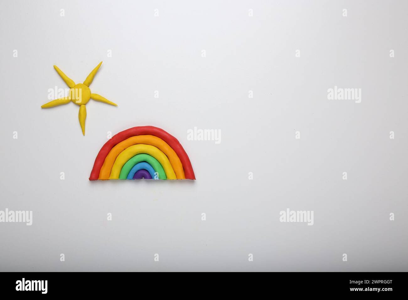 Rainbow and sun made of plasticine on white background, top view Stock ...