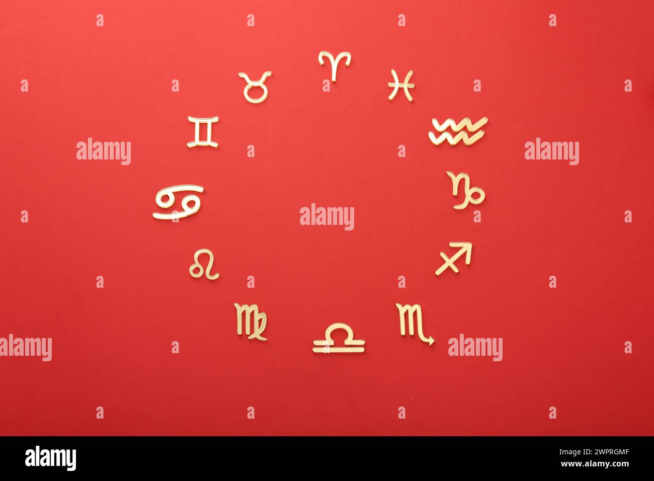 Zodiac signs on red background, flat lay Stock Photo - Alamy