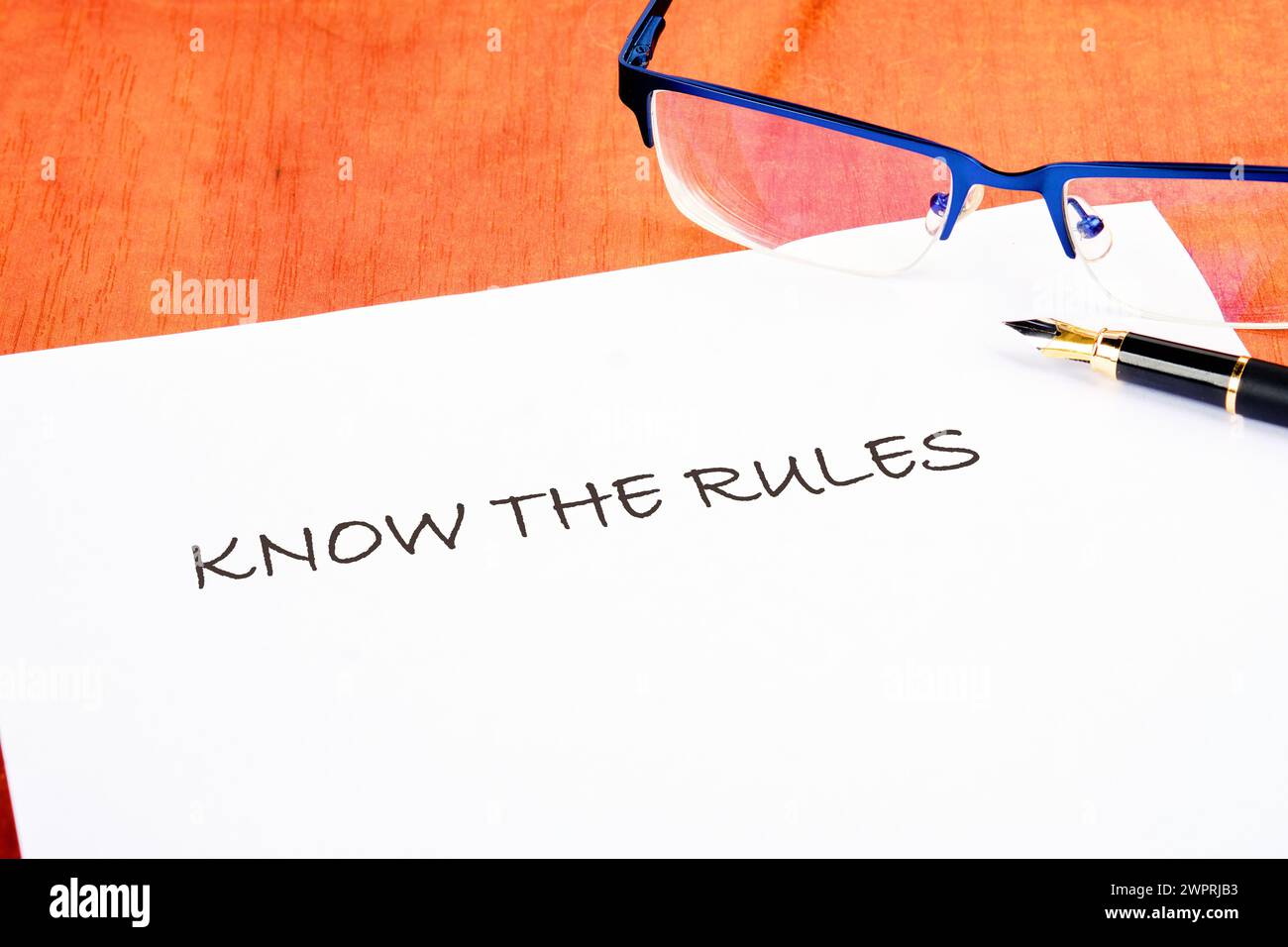 Know the rules text on a white piece of paper on the table next to the ...