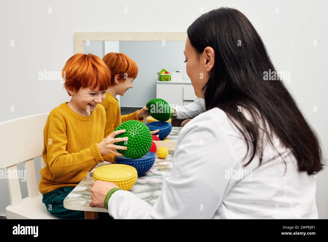 Male child with ASD working with sensory therapist using hedgehog half ... Male child with ASD working with sensory therapist using hedgehog half ...