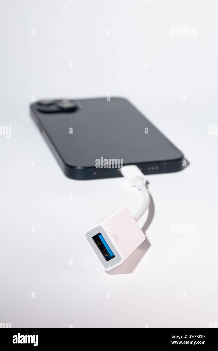 A smartphone connected to a USB adapter as a portable communication ...