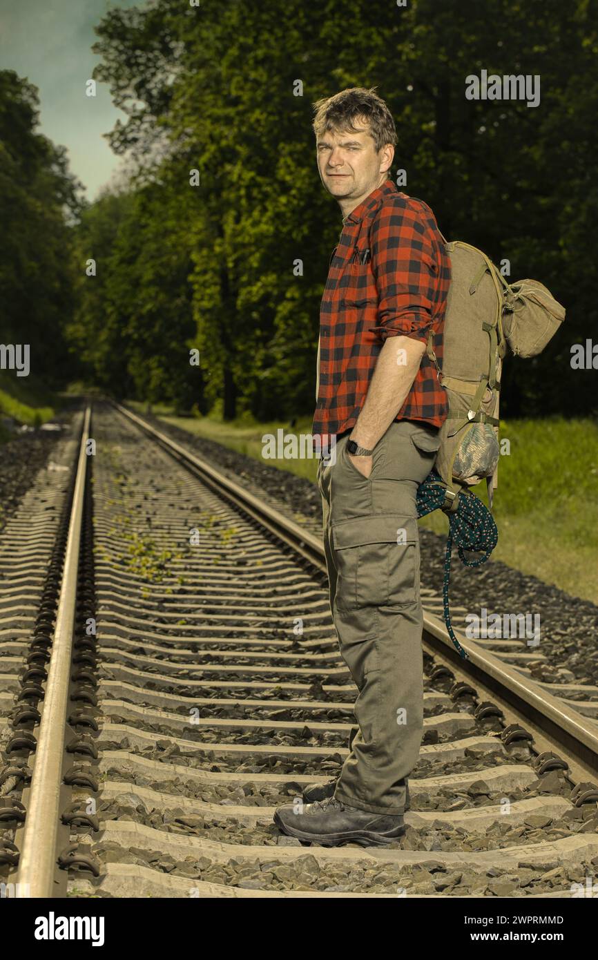 Adventurer with retro haversack wandering nature on railroad way Stock ...