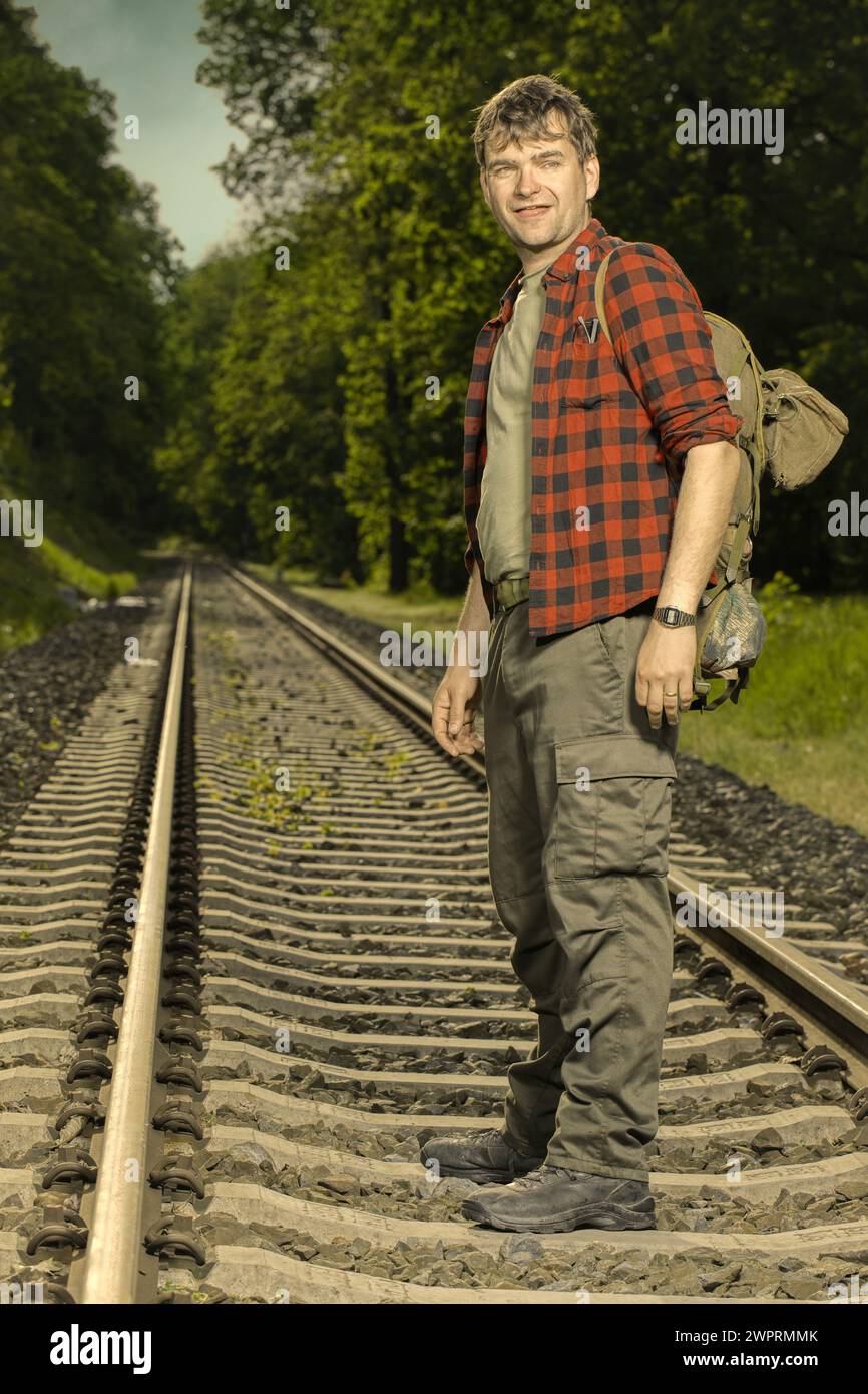 Adventurer with retro haversack wandering nature on railroad way Stock ...