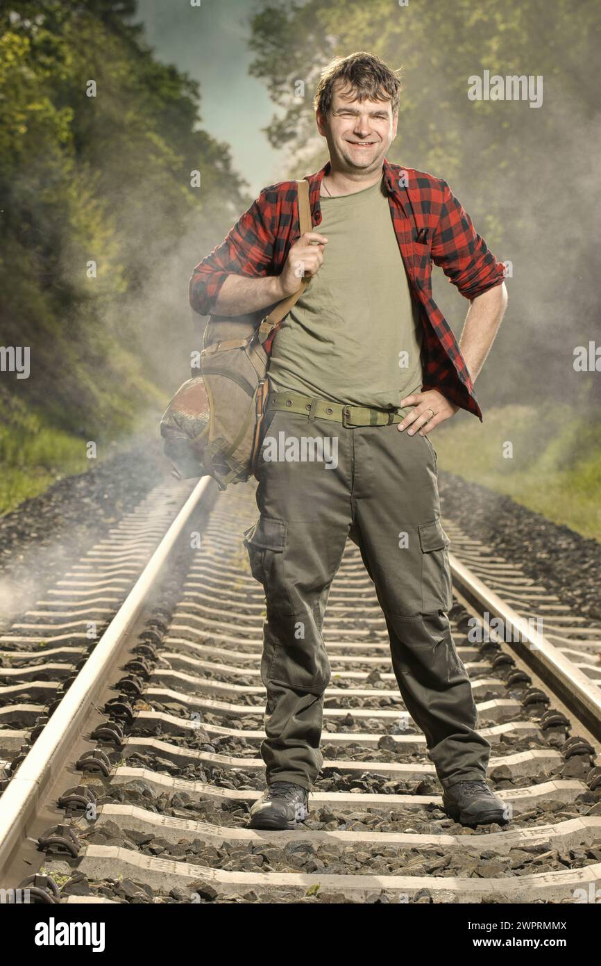 Adventurer with retro haversack wandering nature on railroad way Stock ...