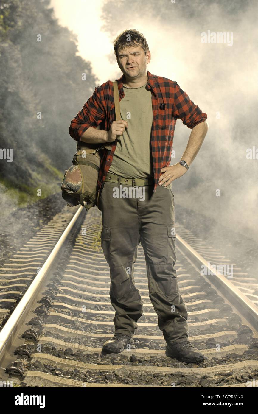 Adventurer with retro haversack wandering nature on railroad way Stock ...