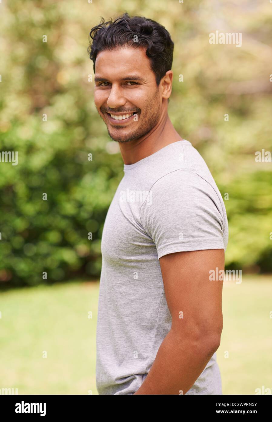Man, outdoor and portrait on grass, smile and green, plants and garden ...