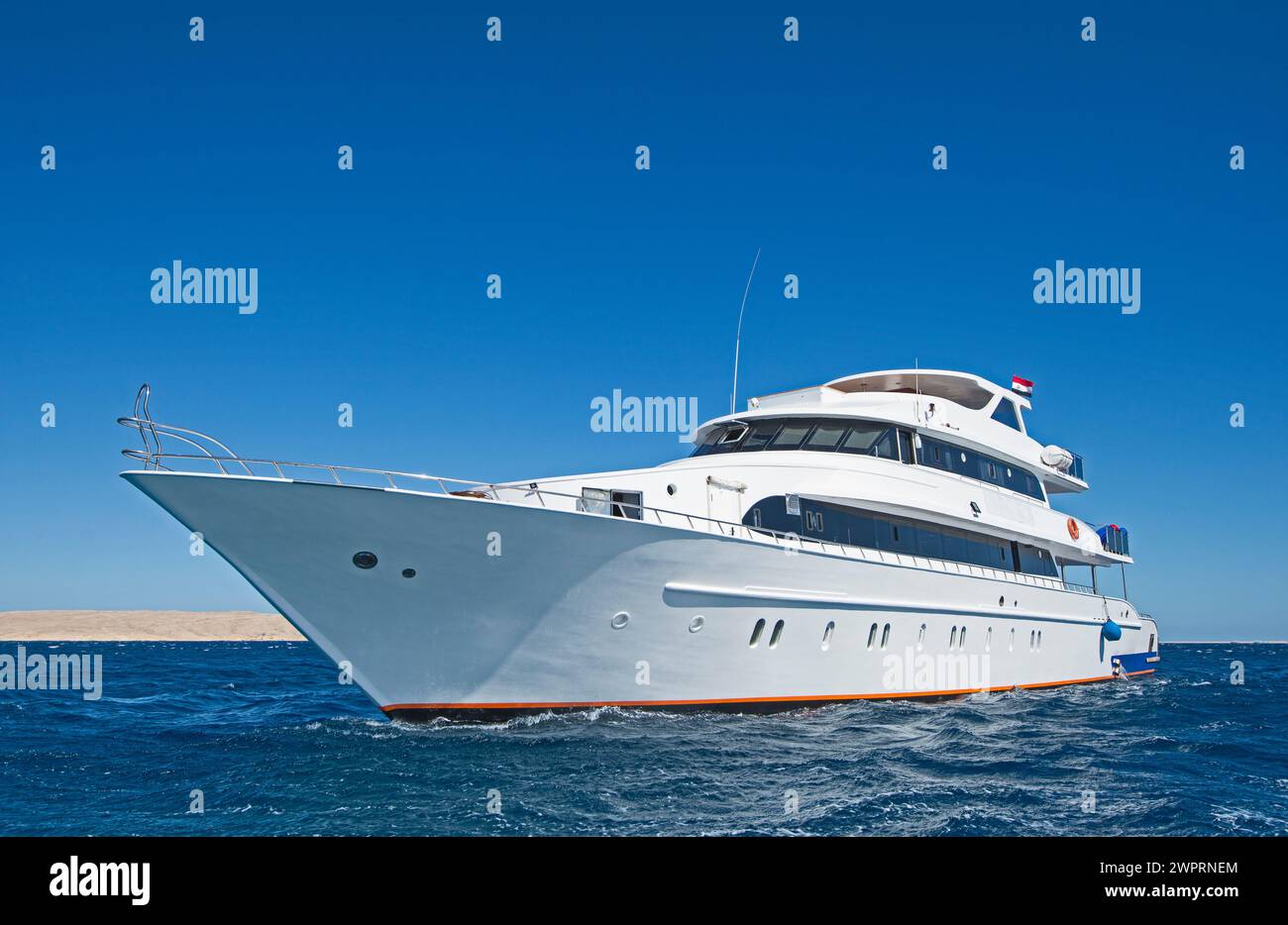 A large luxury private motor yacht under way sailing on tropical sea with bow wave Stock Photo ...
