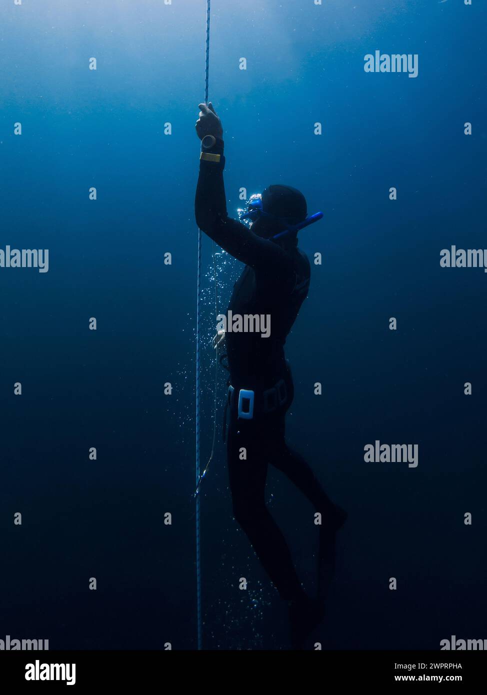 March 04, 2024. Nusa Penida, Indonesia. Men freediver in wetsuit ...