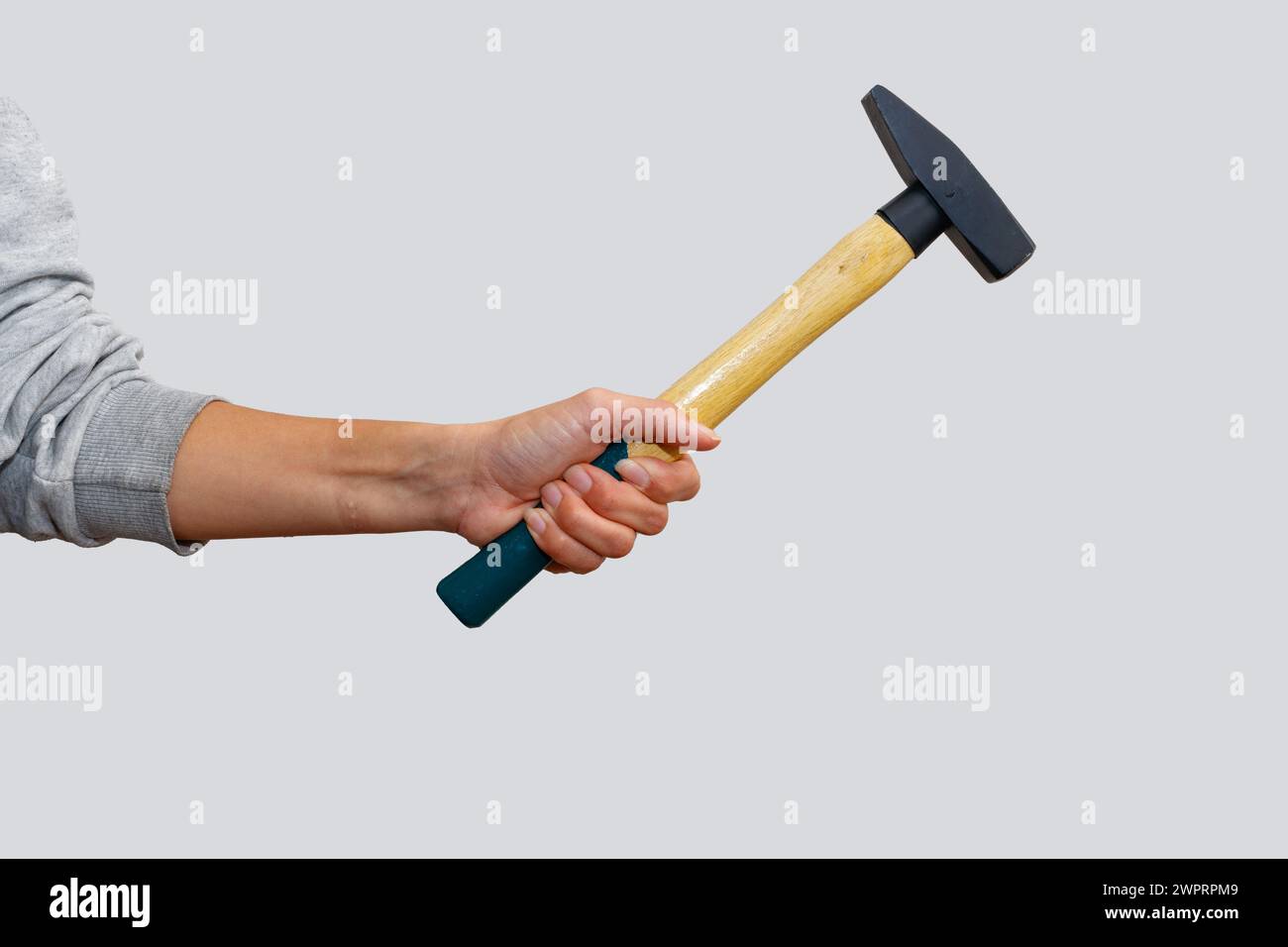 Woman's hand holdin a hammer on an isolated white background. Showing ...