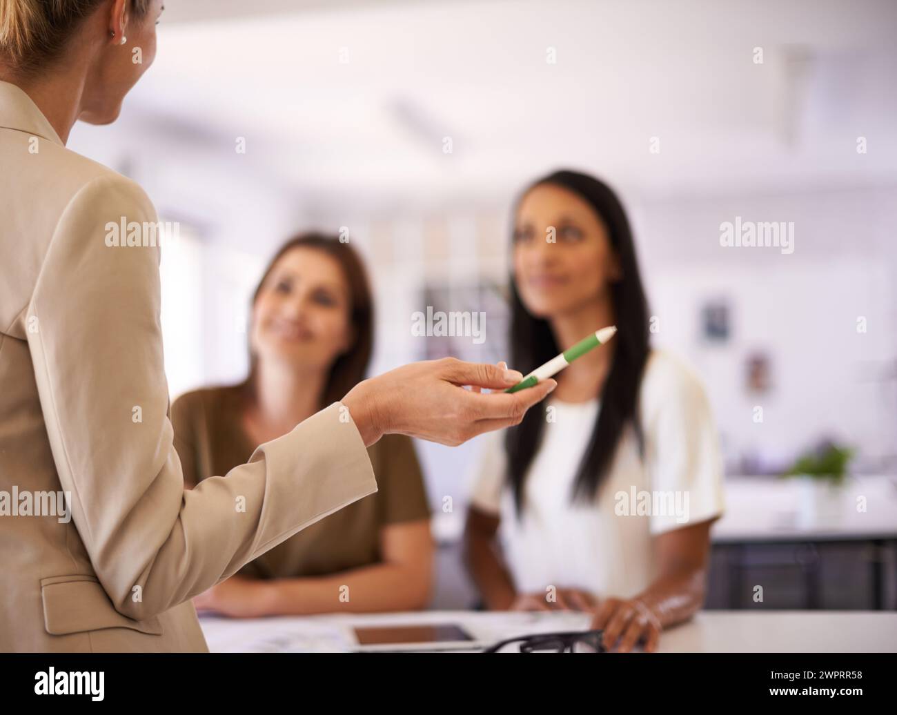 Architect, women and team in discussion at office with hand, back or ...