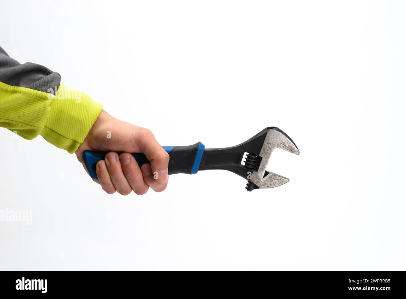 Hand holding wrench on white background Stock Photo - Alamy