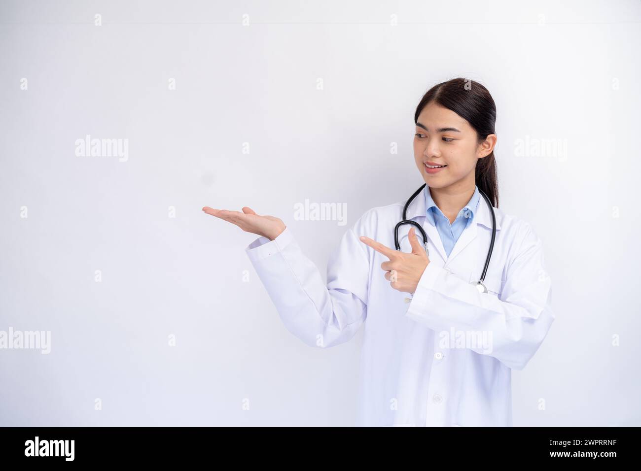 Doctor showing choice between two objects on white background Stock ...