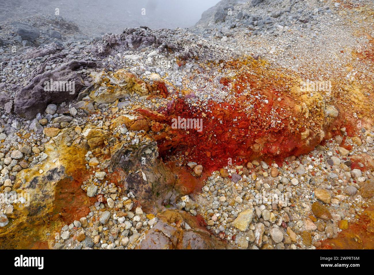 Colorful orange red sulfur mineral deposit around crater of Gunung ...