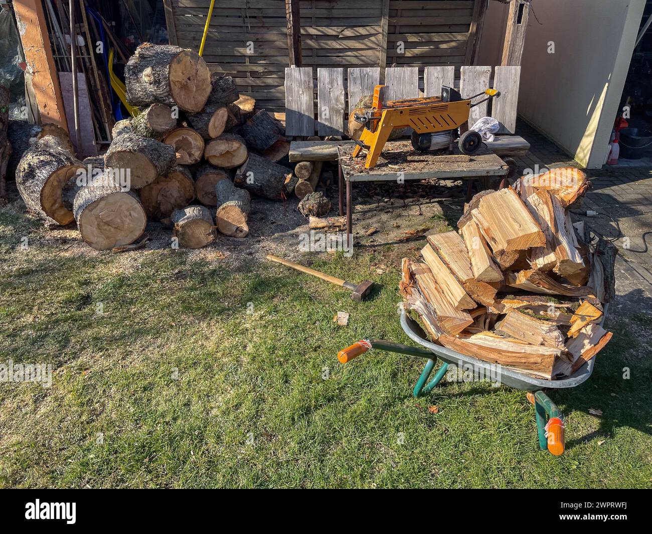 Firewood in a wheelbarrow after splitting with log Stock Photo - Alamy