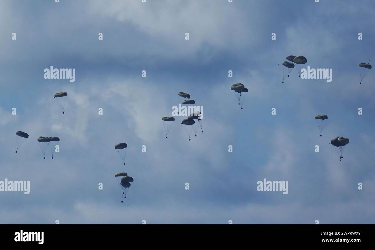 Parachutes of the U.S. military drop humanitarian supplies into the ...