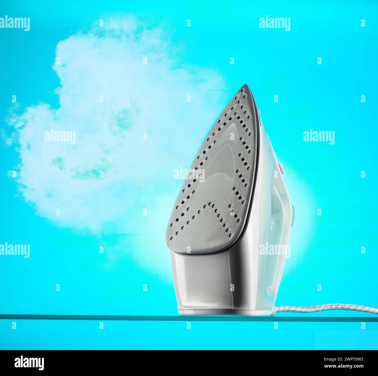 Steam coming from the iron. Iron and steam on a blue background ...