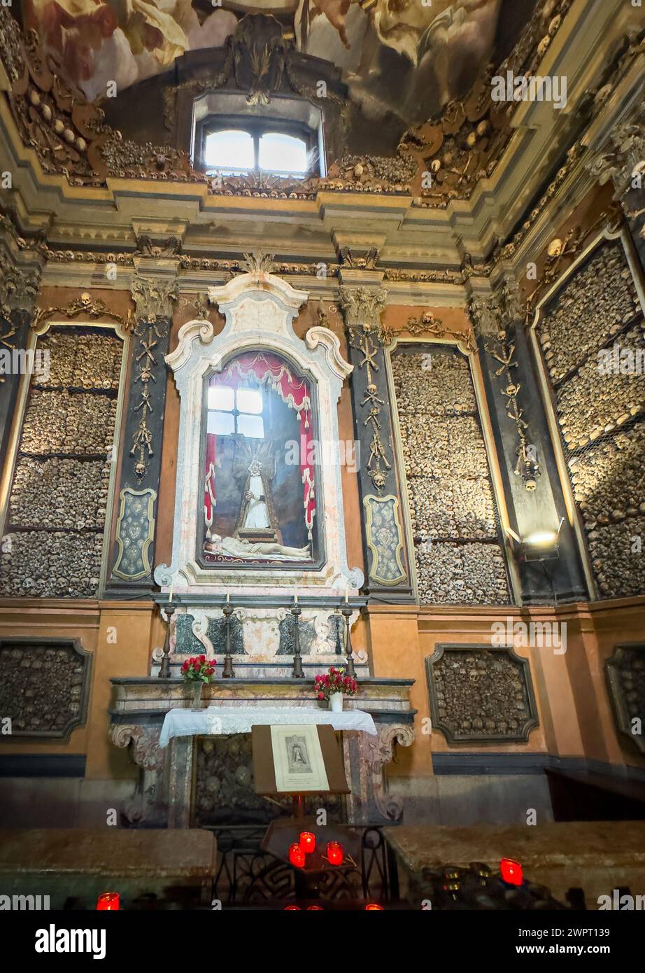 Arranged skulls, bones and paintings in the ossuary inside Chiesa di ...