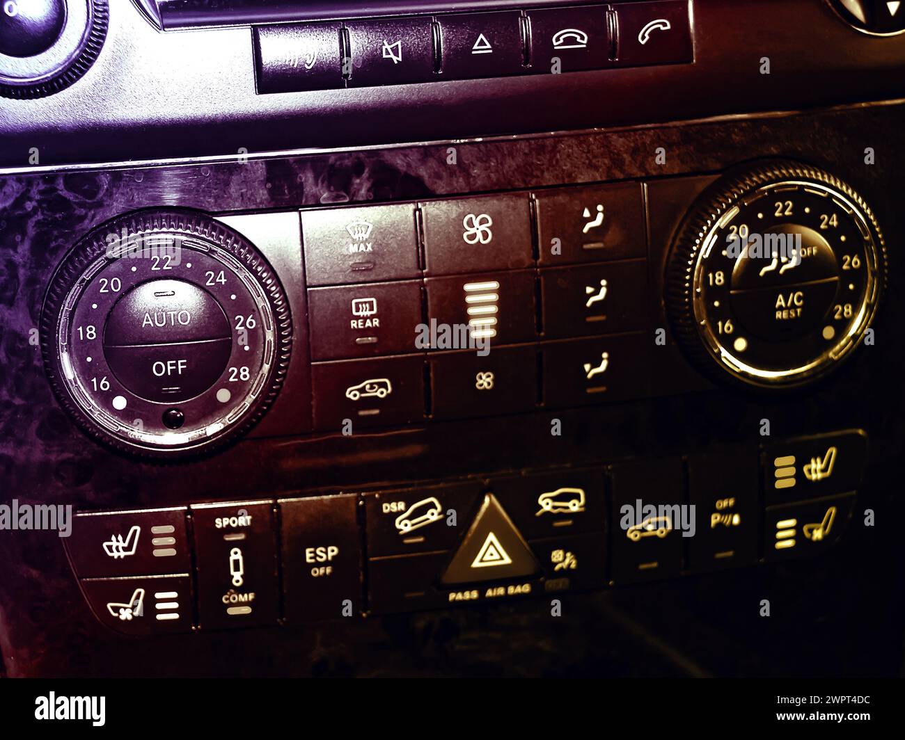 Dashboard car close-up. Many different car buttons with warning lights ...