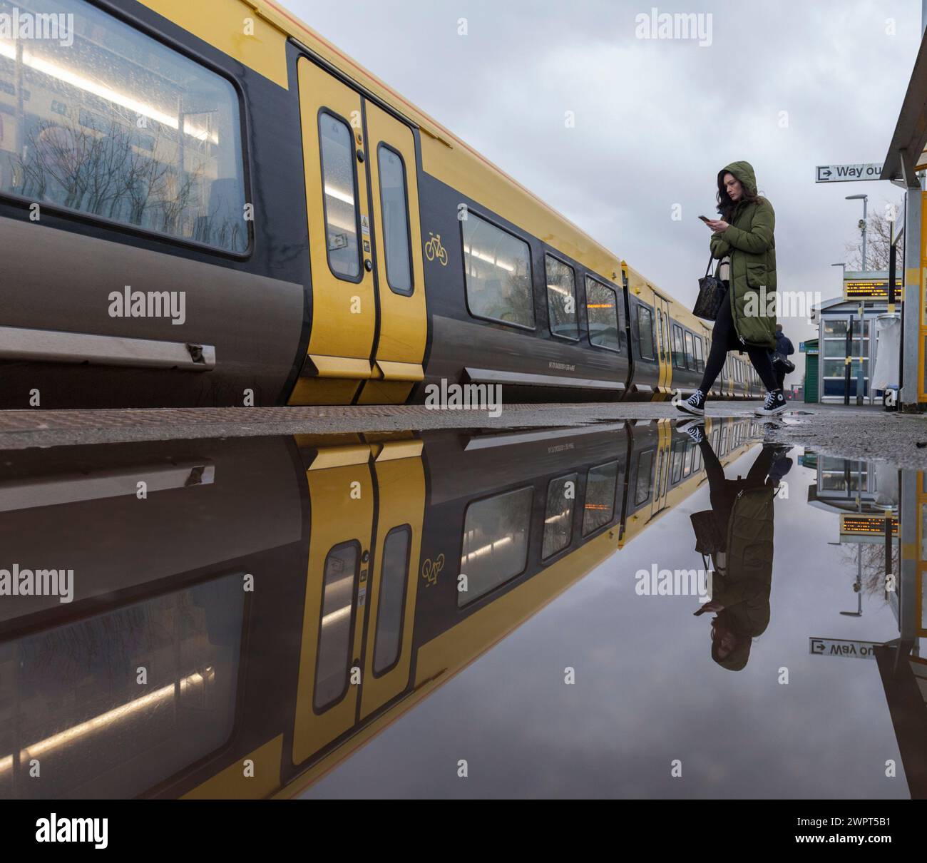 passenger boarding a Merseyrail Stadler class 777 train at Bebington ...