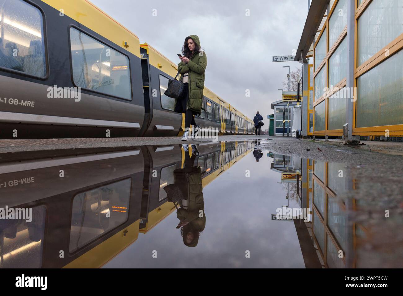 passenger boarding a Merseyrail Stadler class 777 train at Bebington ...