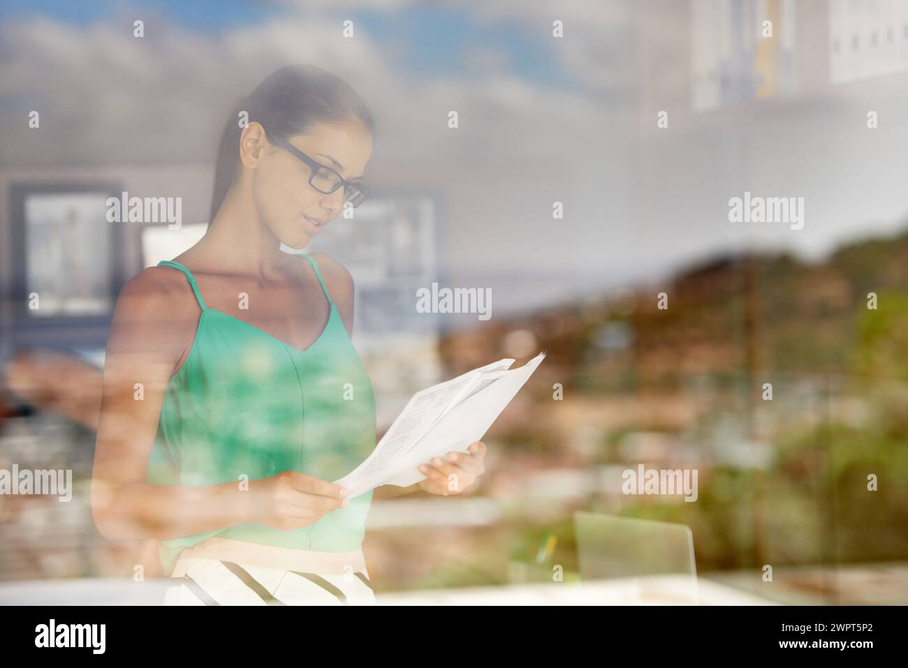 Business woman, window and review documents for project, glasses for reading with editor and ...