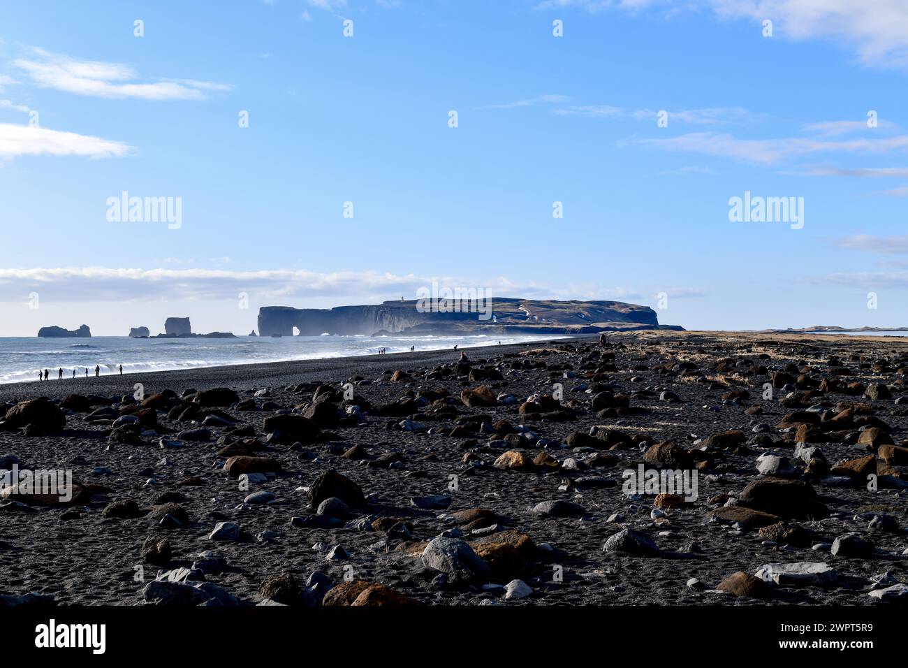 Landscape photograph of tourists on the beach at Reynisfjara Black Sand ...