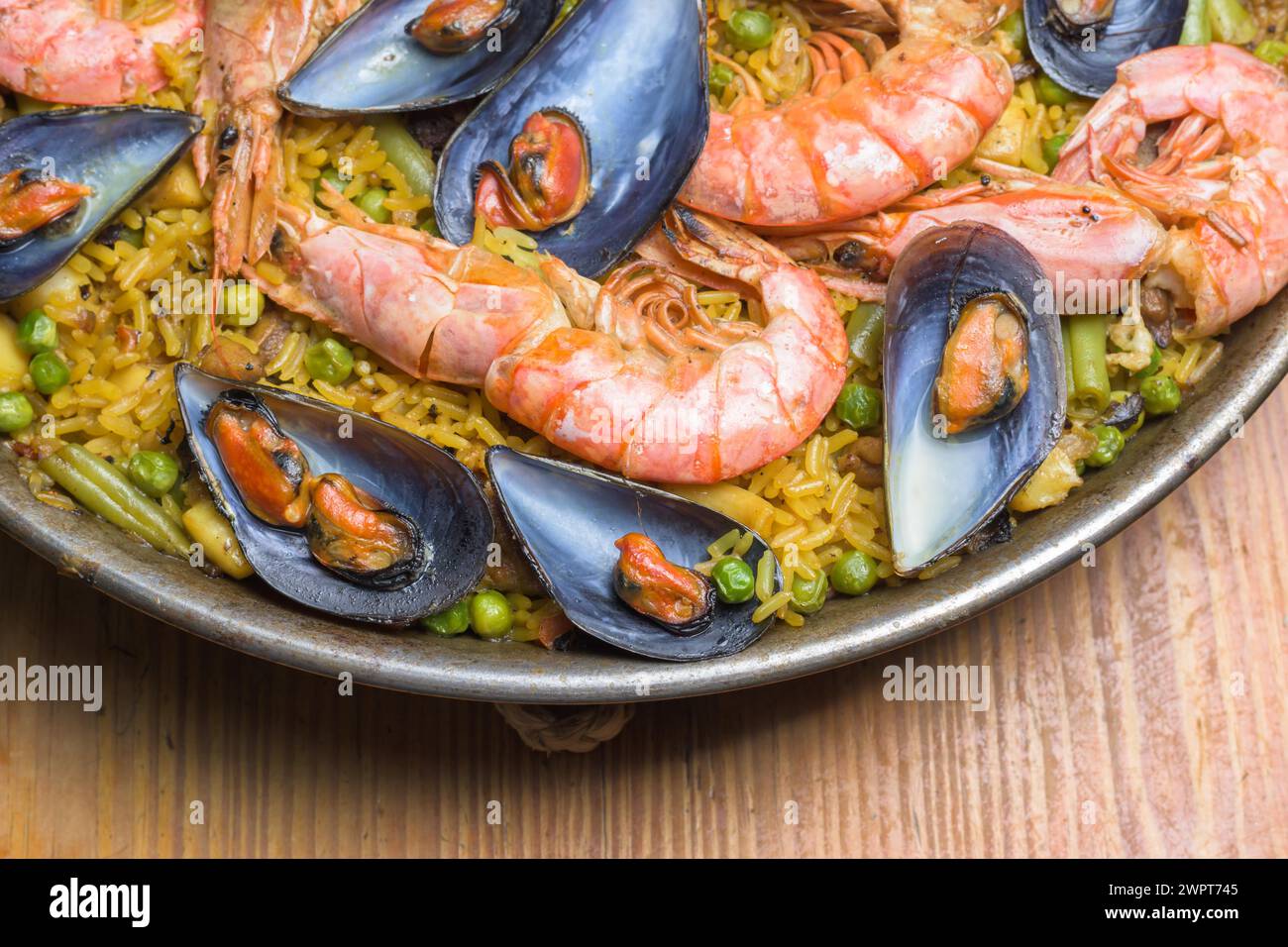 Freshly cooked seafood paella with vibrant colors served in a rustic ...