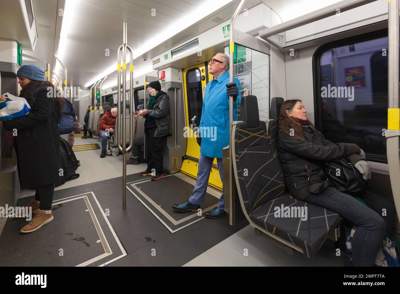 Passengers standing by the doors in a Merseyrail class 777 train ...