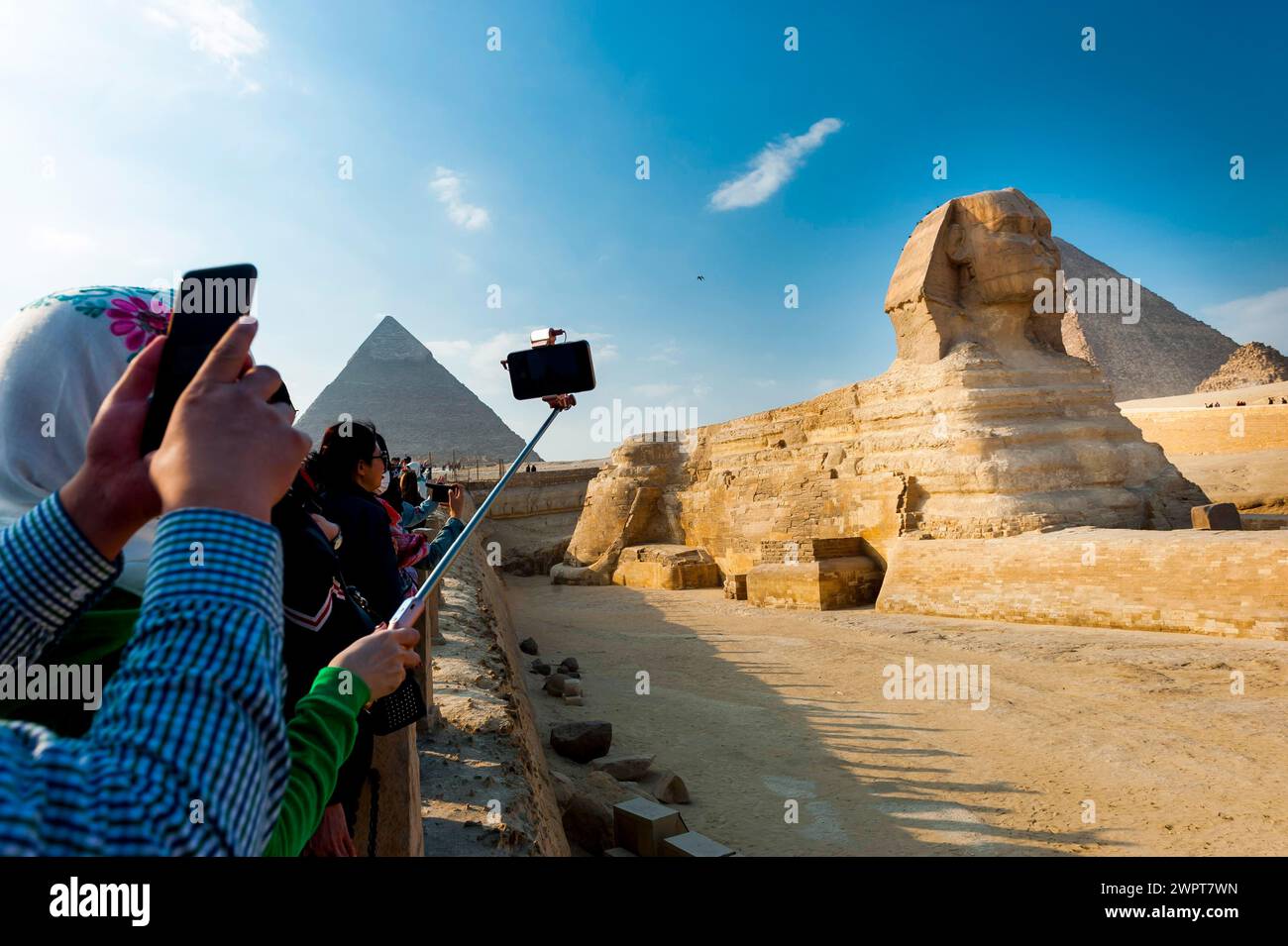 Tourists photograph the Sphinx of Giza, desert, wonder of the world ...