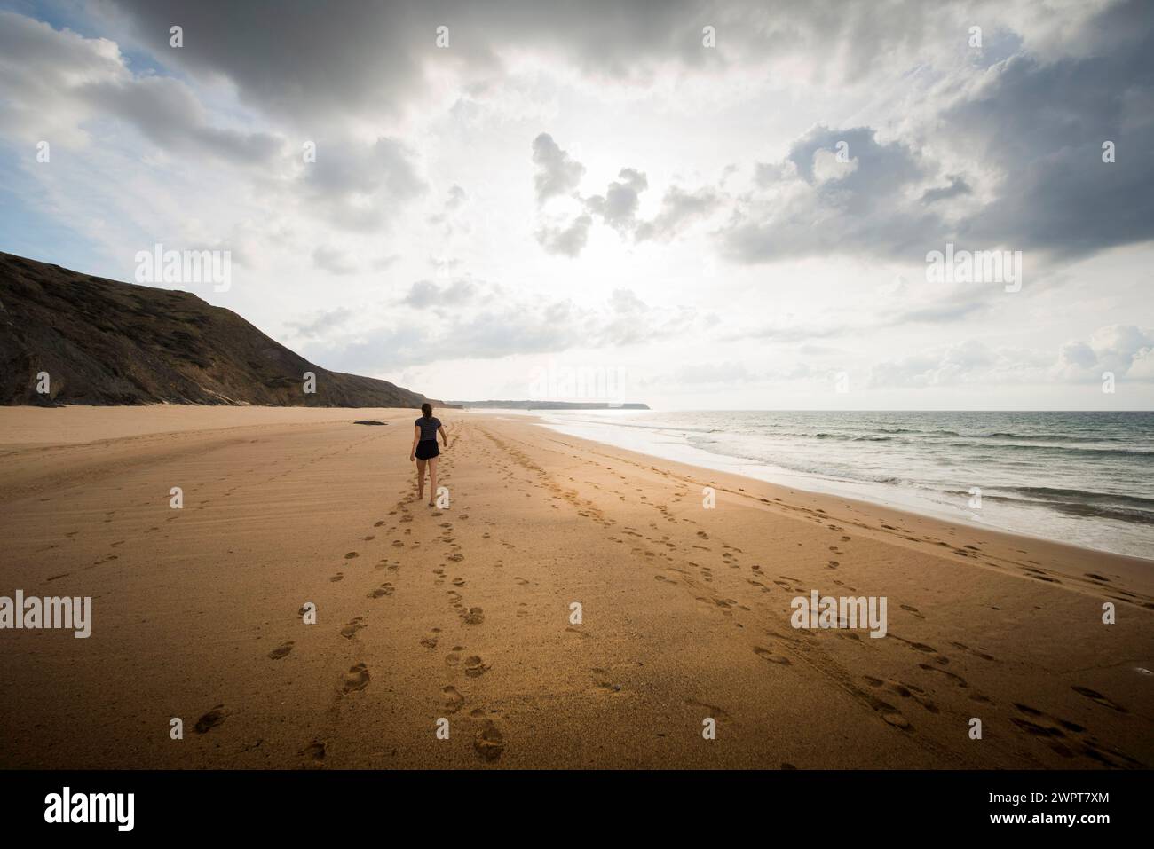 Young woman walking on the beach, emotion, rock, distance, cloudy ...