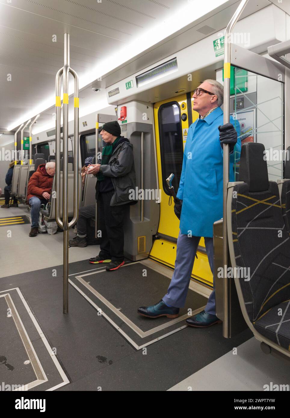 Passengers standing by the doors in a Merseyrail class 777 train ...