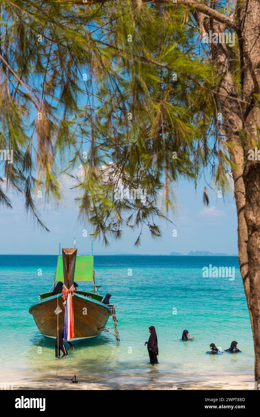 Muslim woman bathing on the beach, longtail boat, wooden boat, boat ...