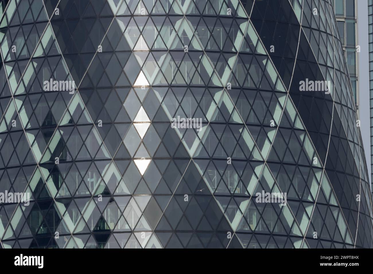 The Gherkin skyscraper building close up of window details with a ...