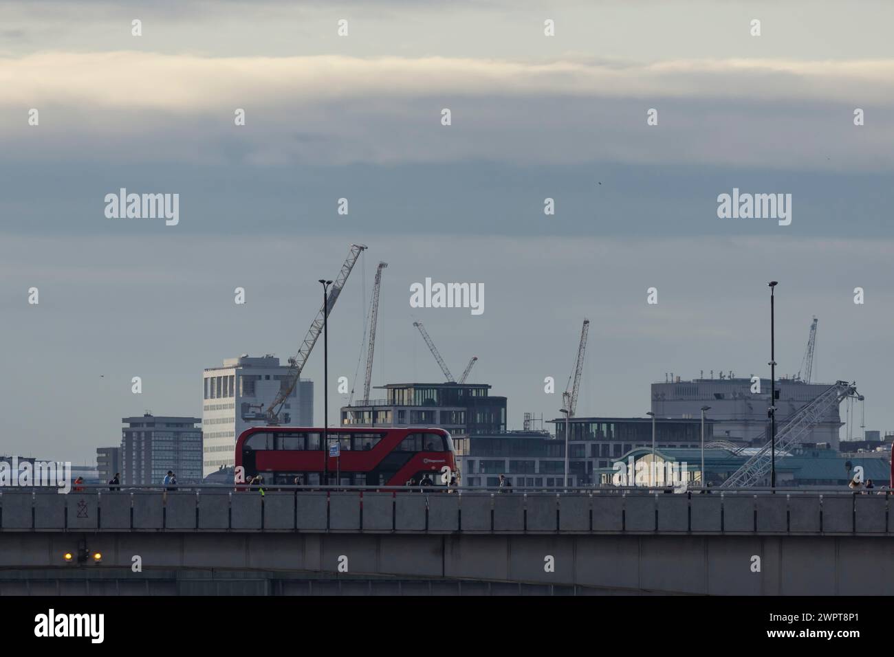 Red bus crosses over London Bridge, City of London, England, United ...