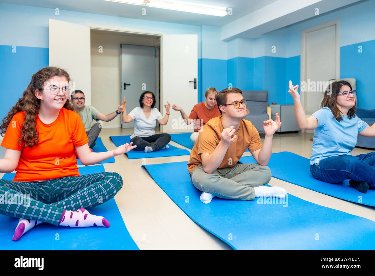 Disabled people enjoying practicing lotus pose during yoga class ...