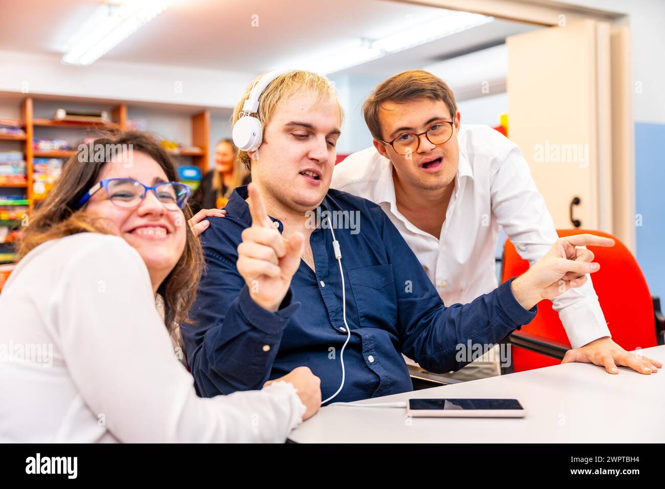 Disabled people having fun listening to music together in a leisure ...