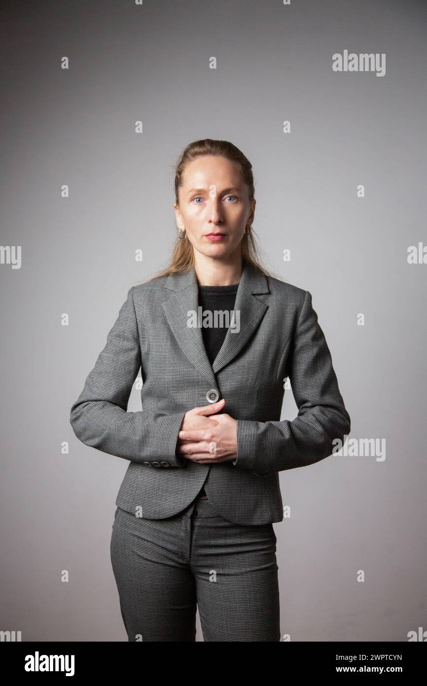 Portrait of a business woman with her hands folded on her stomach up to ...