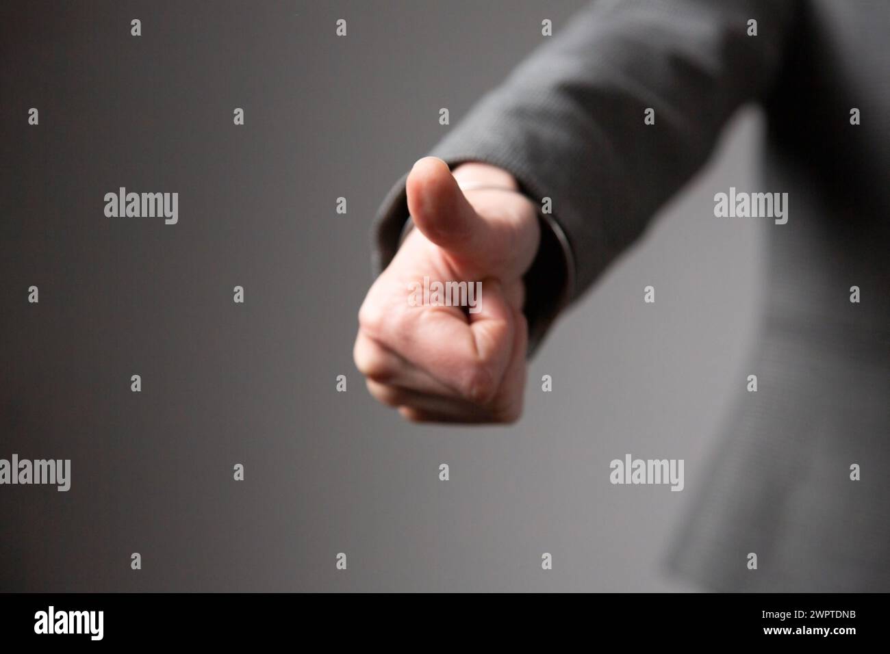Hand of a business woman with her arm extended forward in a gesture ...
