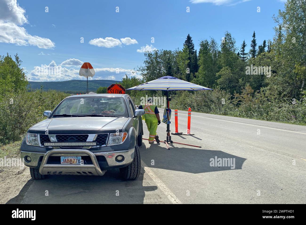 Construction worker directing traffic at the beginning of a ...