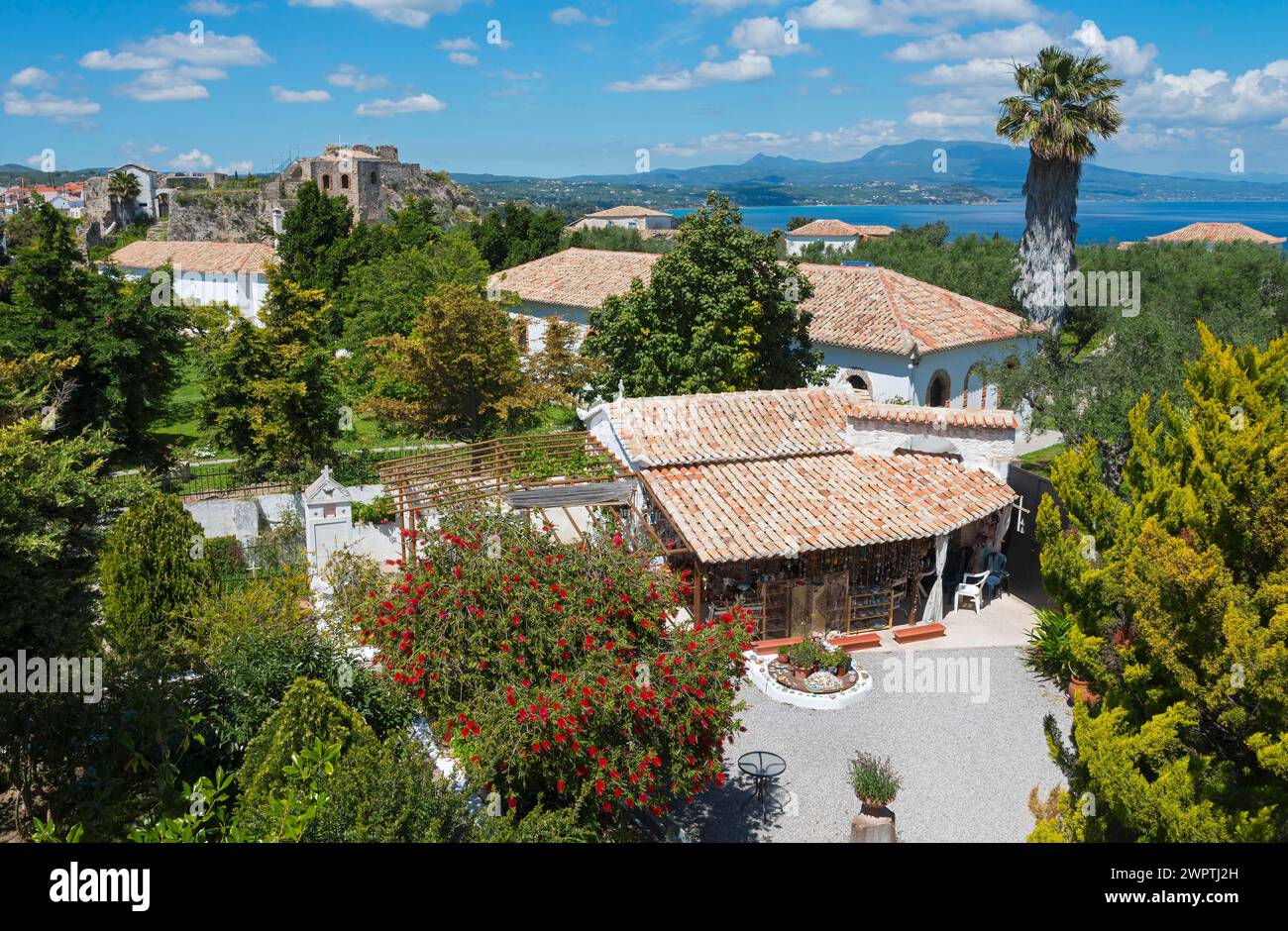Monastery with buildings with terracotta roofs, sea view and a castle ...