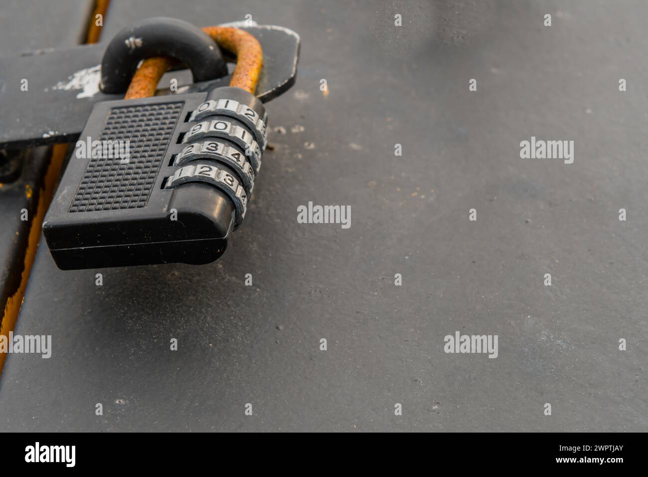 Closeup of rusty metal combination lock fastened to latch in South ...