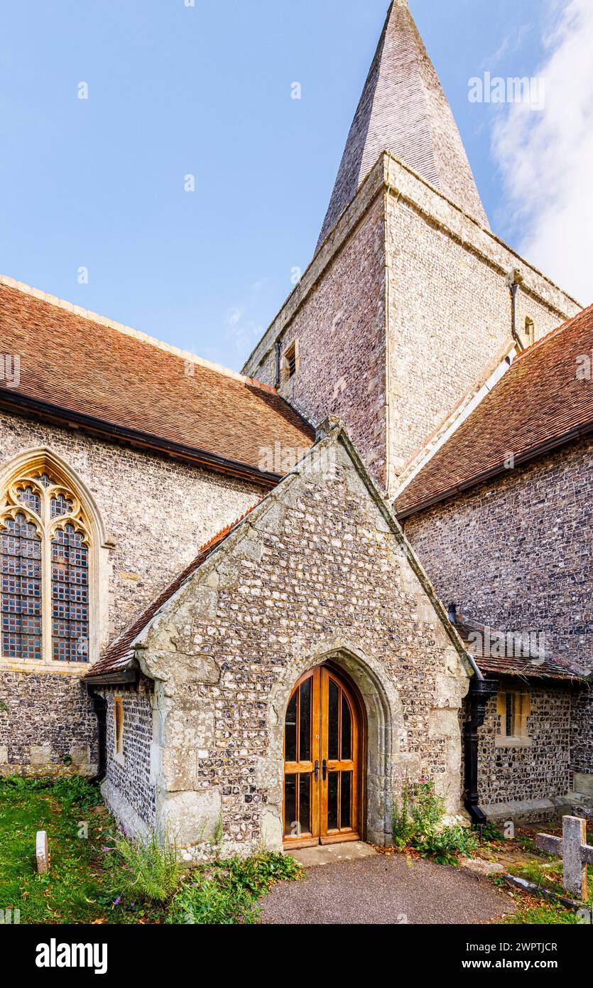 Flint stone walls and rear entrance to the Church of St Andrew in ...