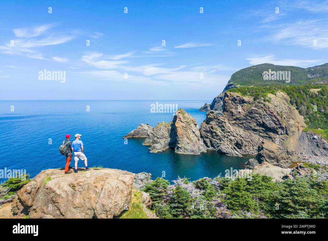 Aerial view, drone photo: Two men standing on a cliff above Bottle Cove ...