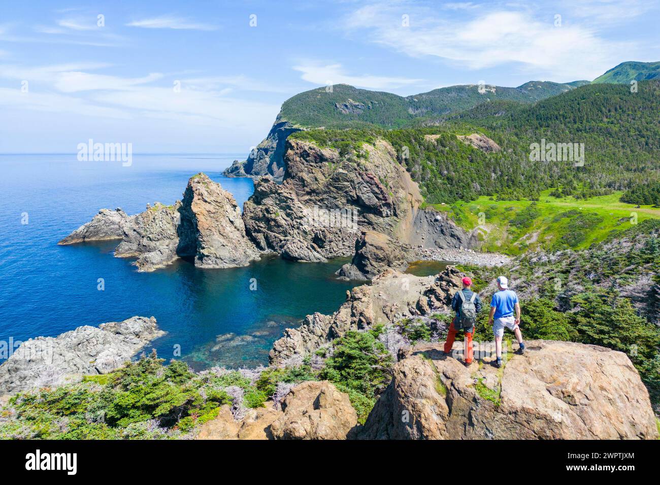 Aerial view, drone photo: Two men standing on a cliff above Bottle Cove ...