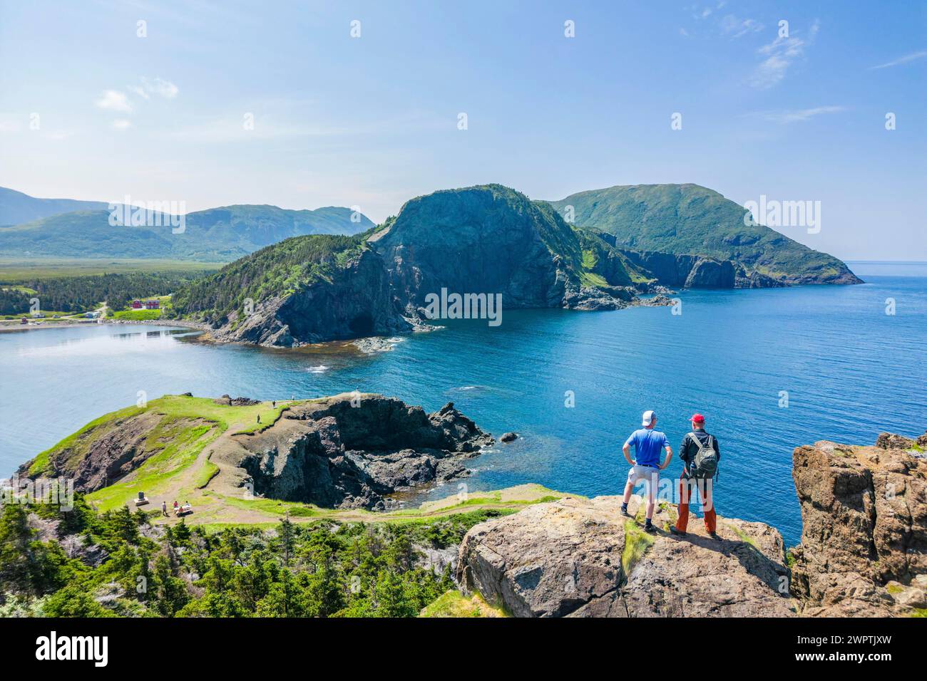 Aerial view, drone photo: Two men standing on a cliff above Bottle Cove ...