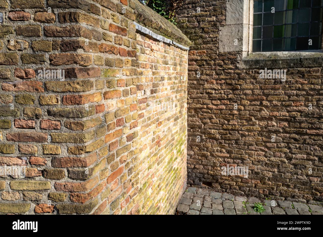Texture-rich brick wall in the shade with clearly visible patterns ...