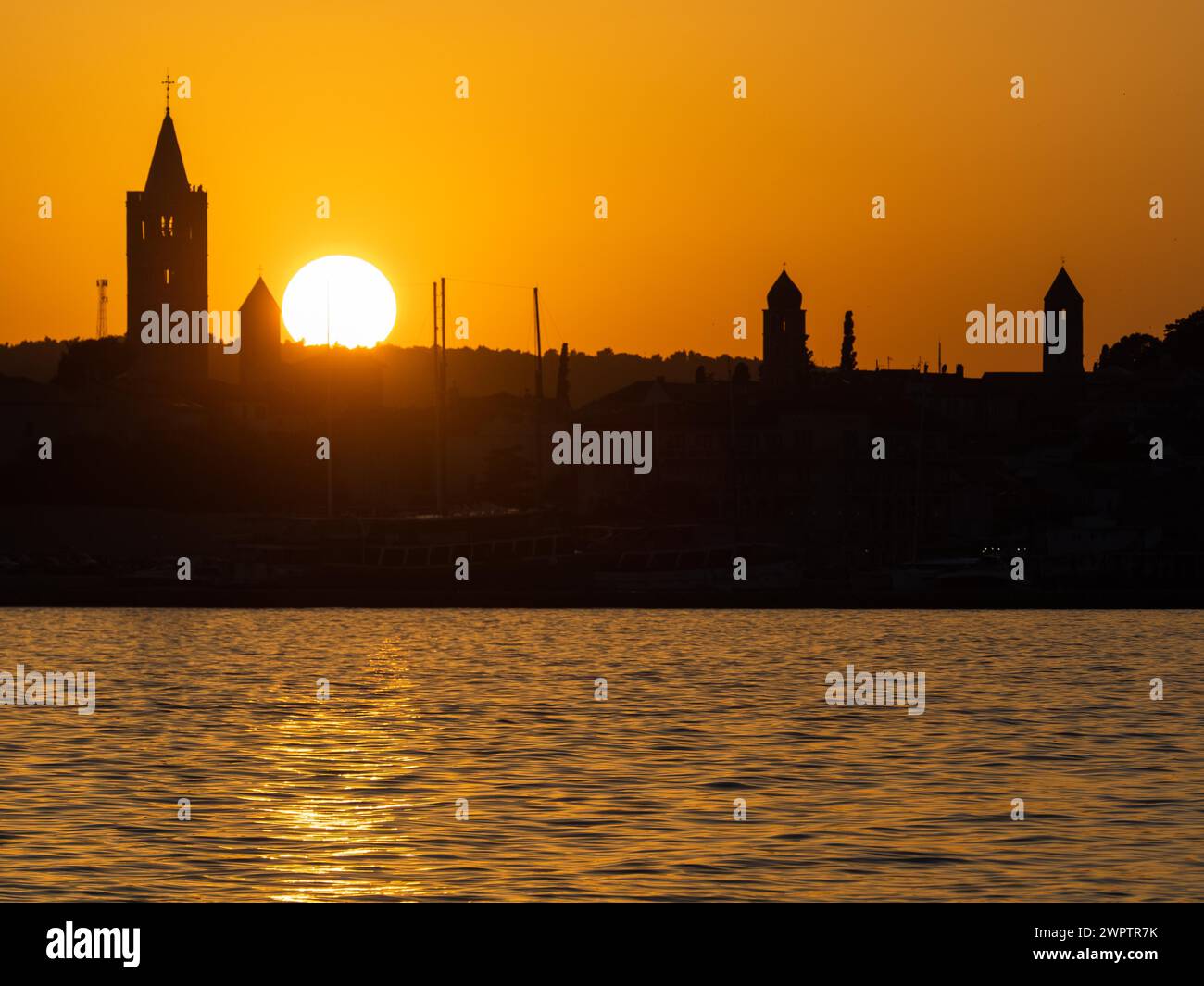 Sunset, silhouette of the church towers of Rab, town of Rab, island of ...
